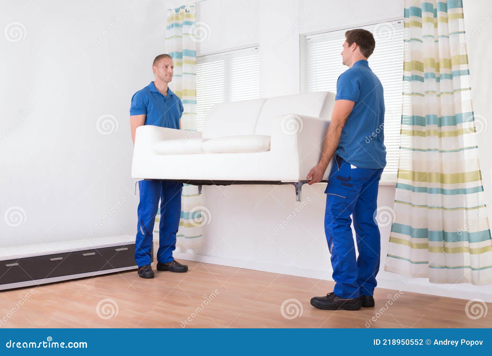 Movers Carrying Sofa at Home Stock Photo - Image of furniture, delivery ...