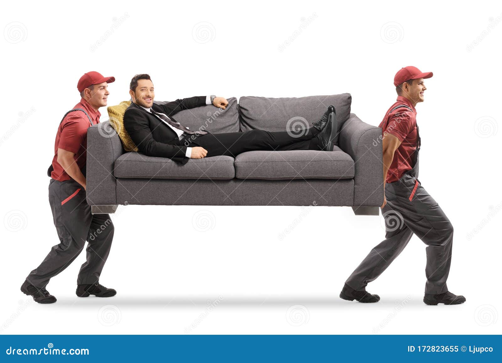 Movers Carrying a Sofa with a Man in a Suit Relaxing on the Sofa Stock ...