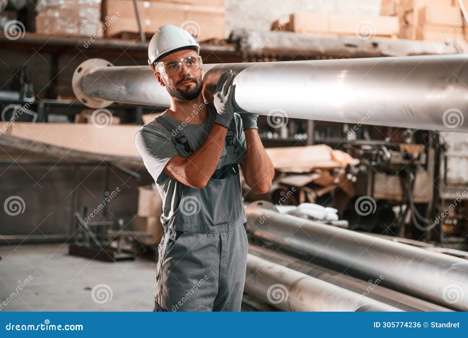 Moving Big Metal Pipe. Young Factory Worker in Grey Uniform Stock Photo ...