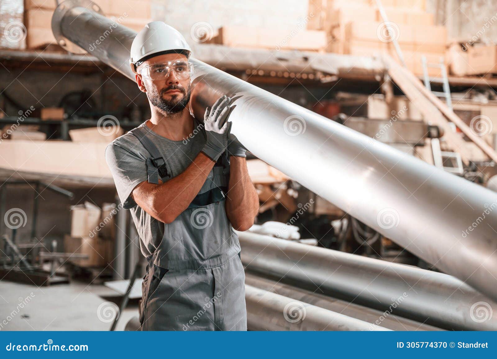 Moving Big Metal Pipe. Young Factory Worker in Grey Uniform Stock Photo ...