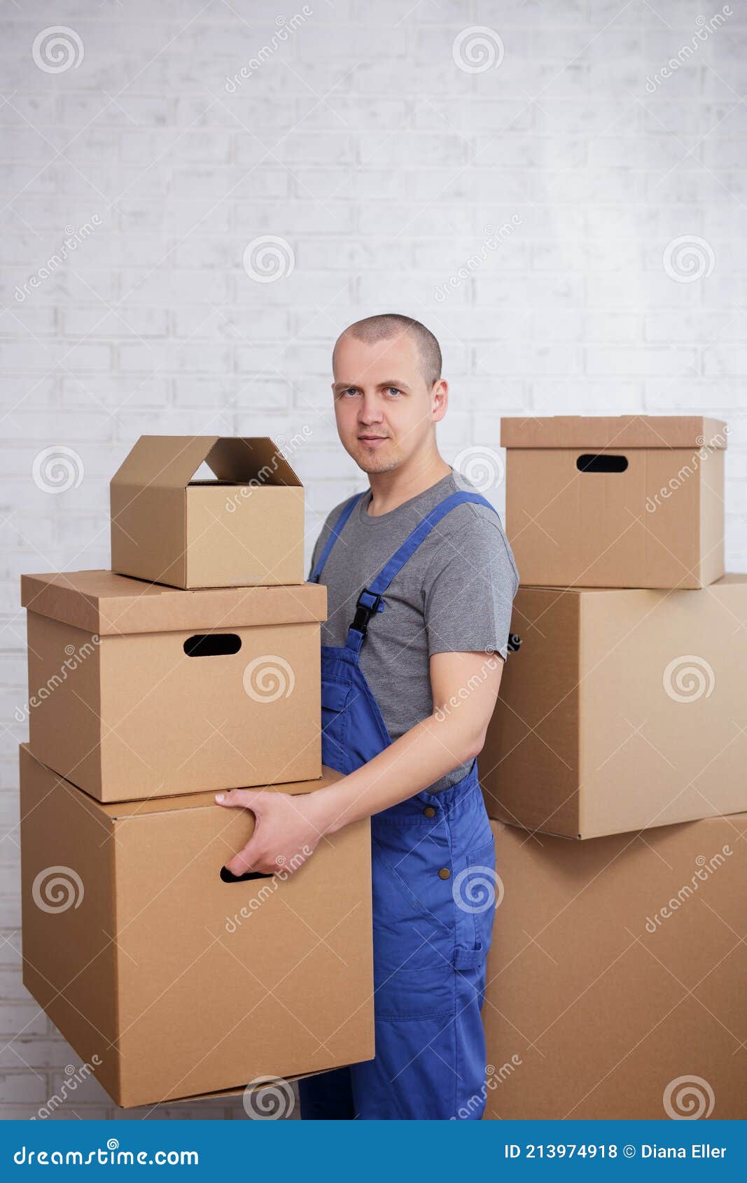 Moving Day Concept - Handsome Man Loader Holding Many Boxes â€“ Copy ...