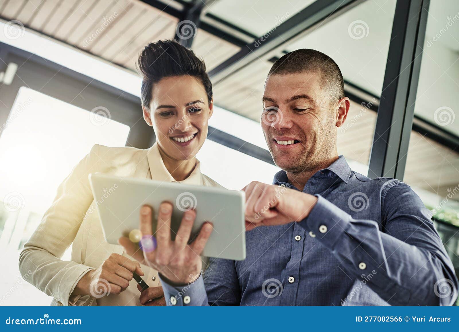 Moving Forward, Together. Two Colleagues Using a Tablet while Meeting ...