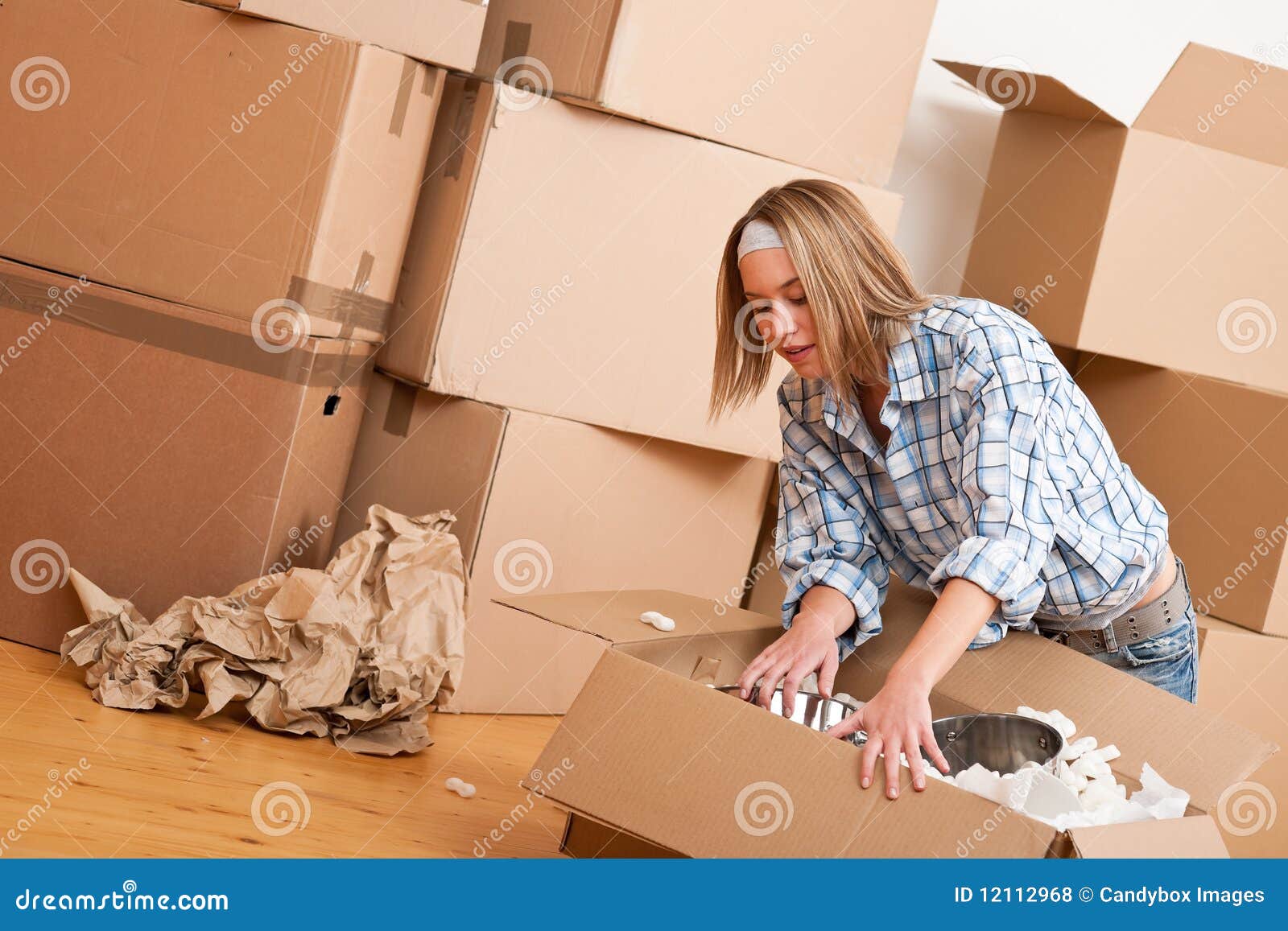Moving House: Happy Woman Unpacking Box Stock Photo - Image of kneeling ...