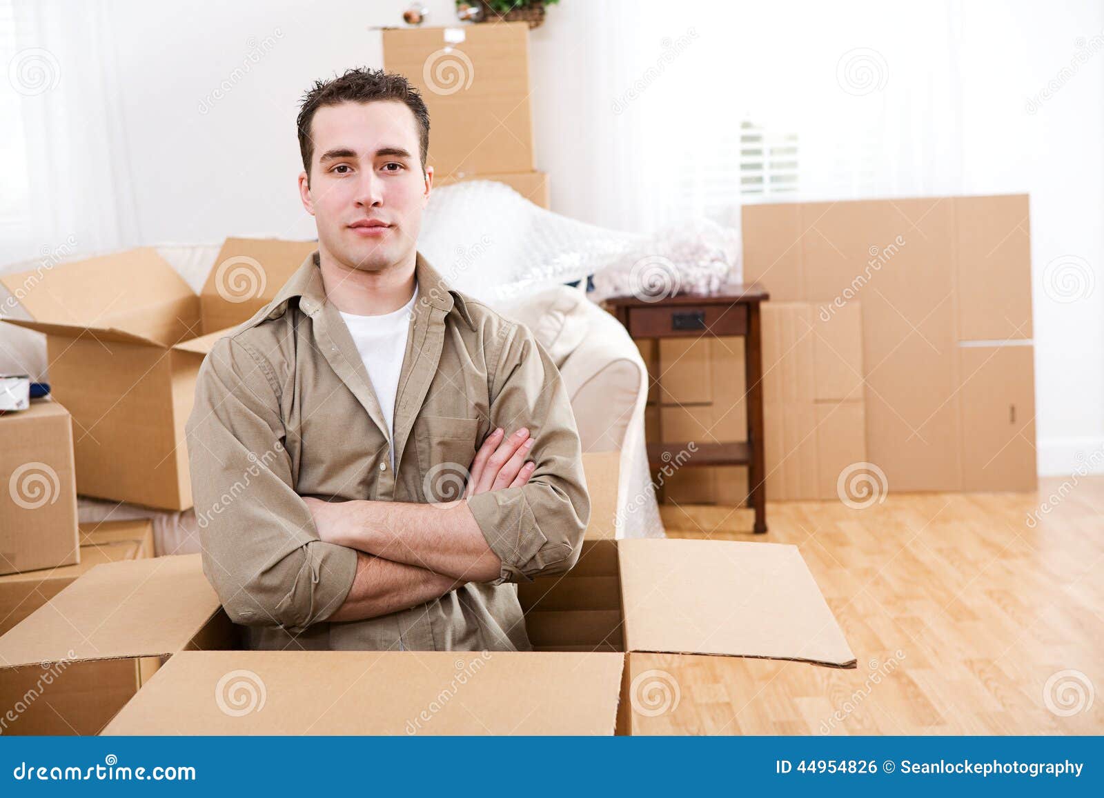 Moving: Man Sits Inside Empty Packing Box Stock Photo - Image of ...