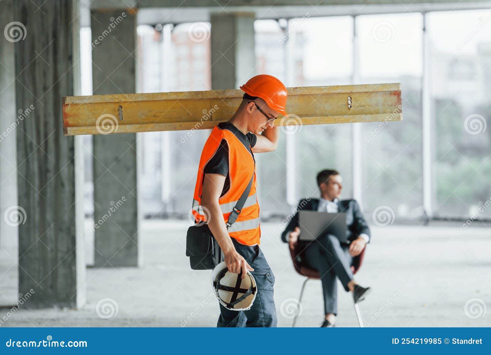 Moving Object. Man in Suit and Handyman in Orange Protective Wear is ...