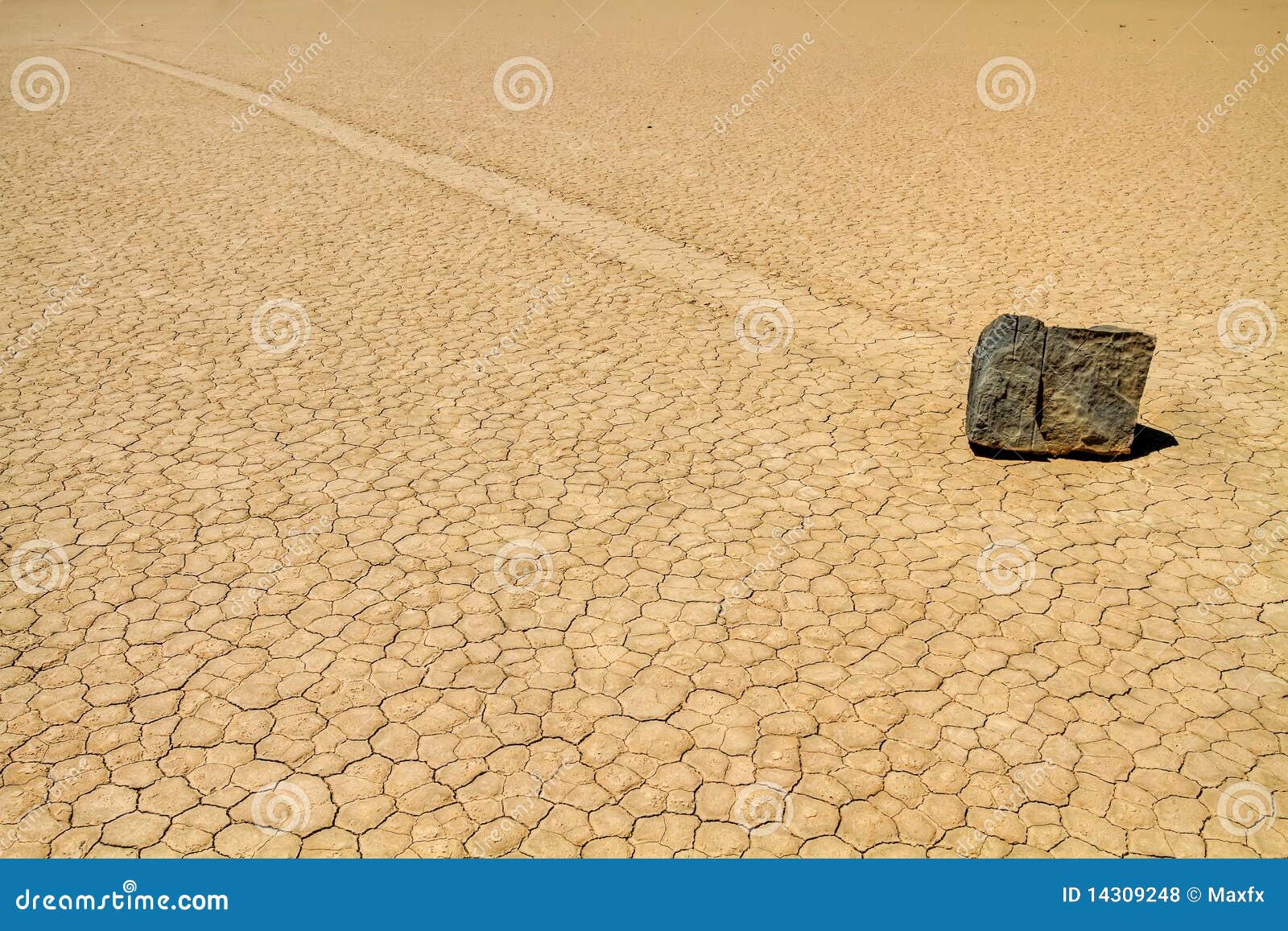 Moving Rock on Cracked Desert Ground Stock Photo - Image of desert ...