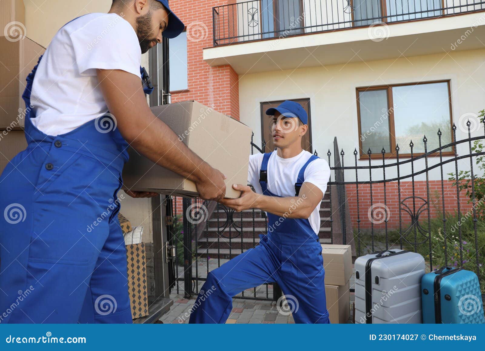 Moving Service Workers Unloading Boxes Near House Stock Image - Image ...