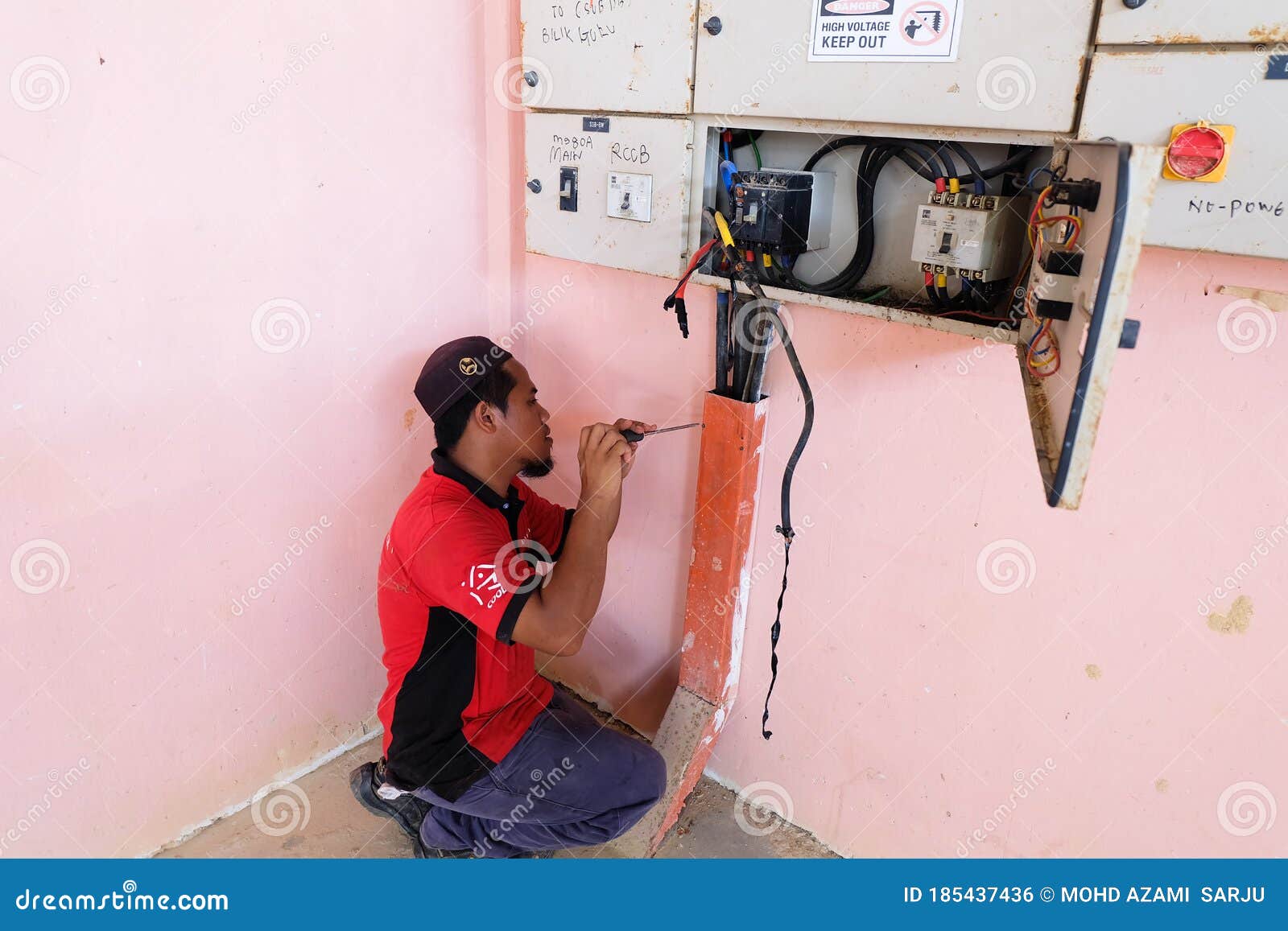 Technician Wiring Cable In Front Of Electrical Panel For Control And ...