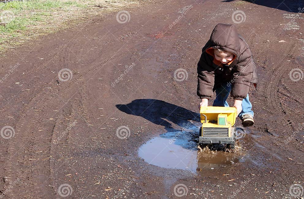 Mud Puddle Fun stock photo. Image of playtime, pushing - 18970414