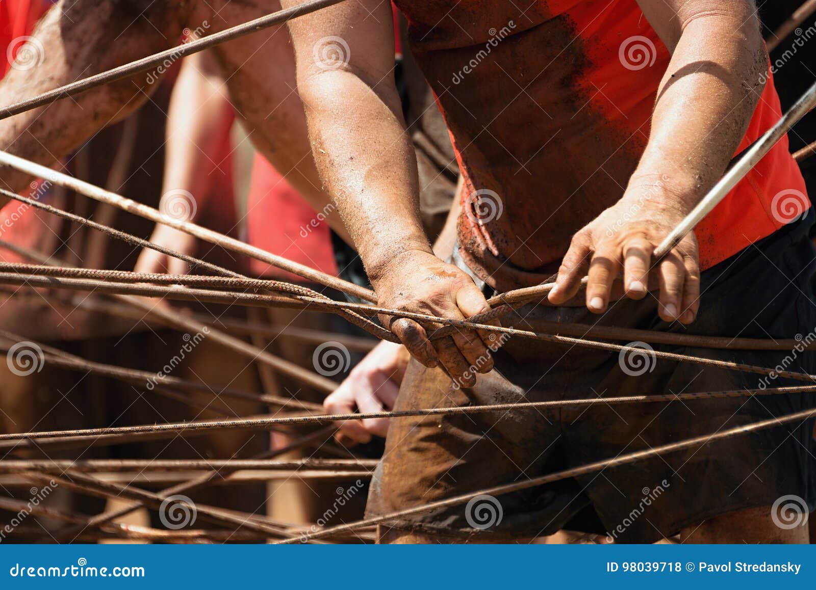 Mud Race Runners,defeating Obstacles By Using Rope Stock Photography ...