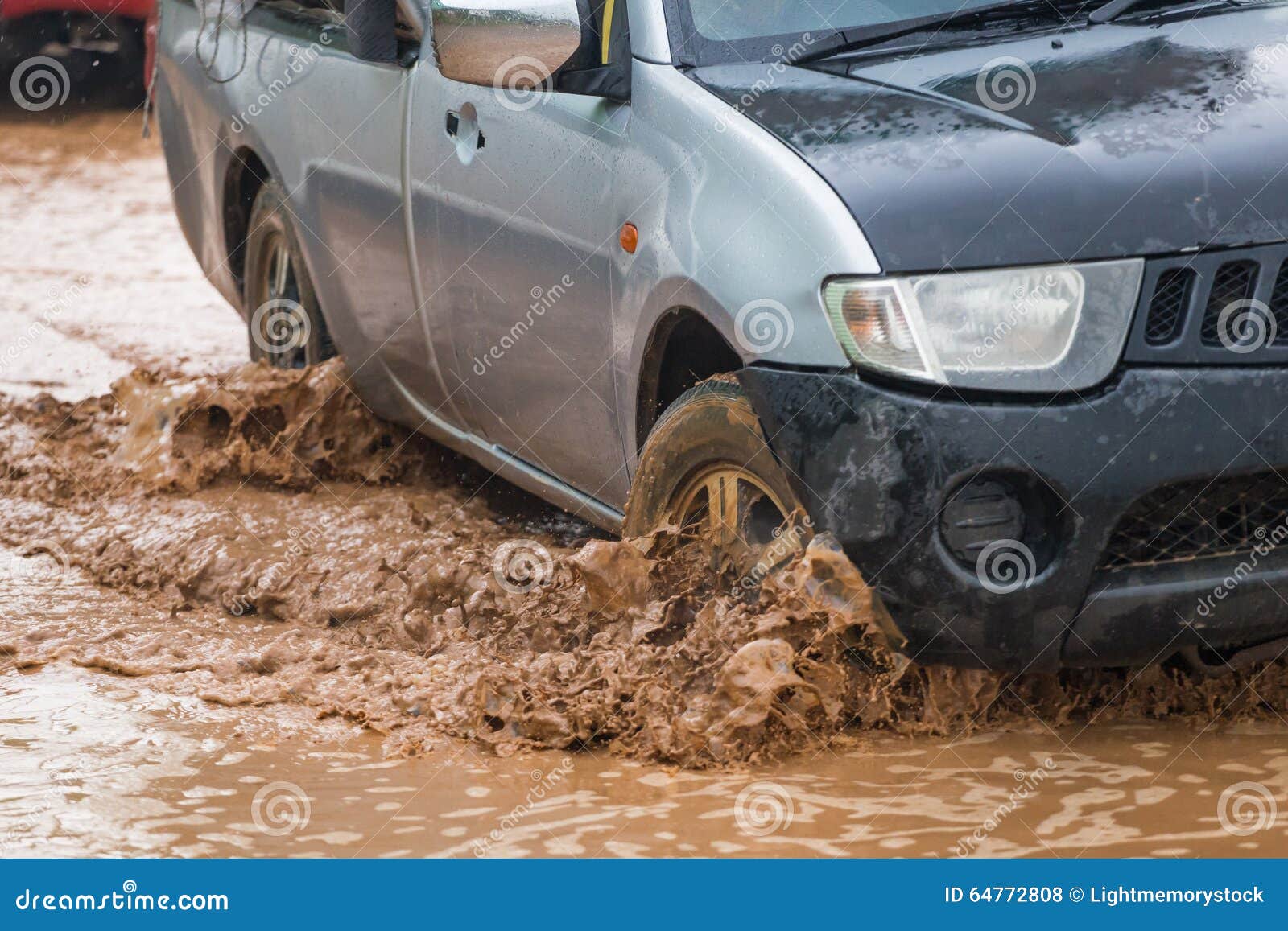 Mud Splash By A Car As It Goes Through Flood Water Stock Photo | CartoonDealer.com #64772916