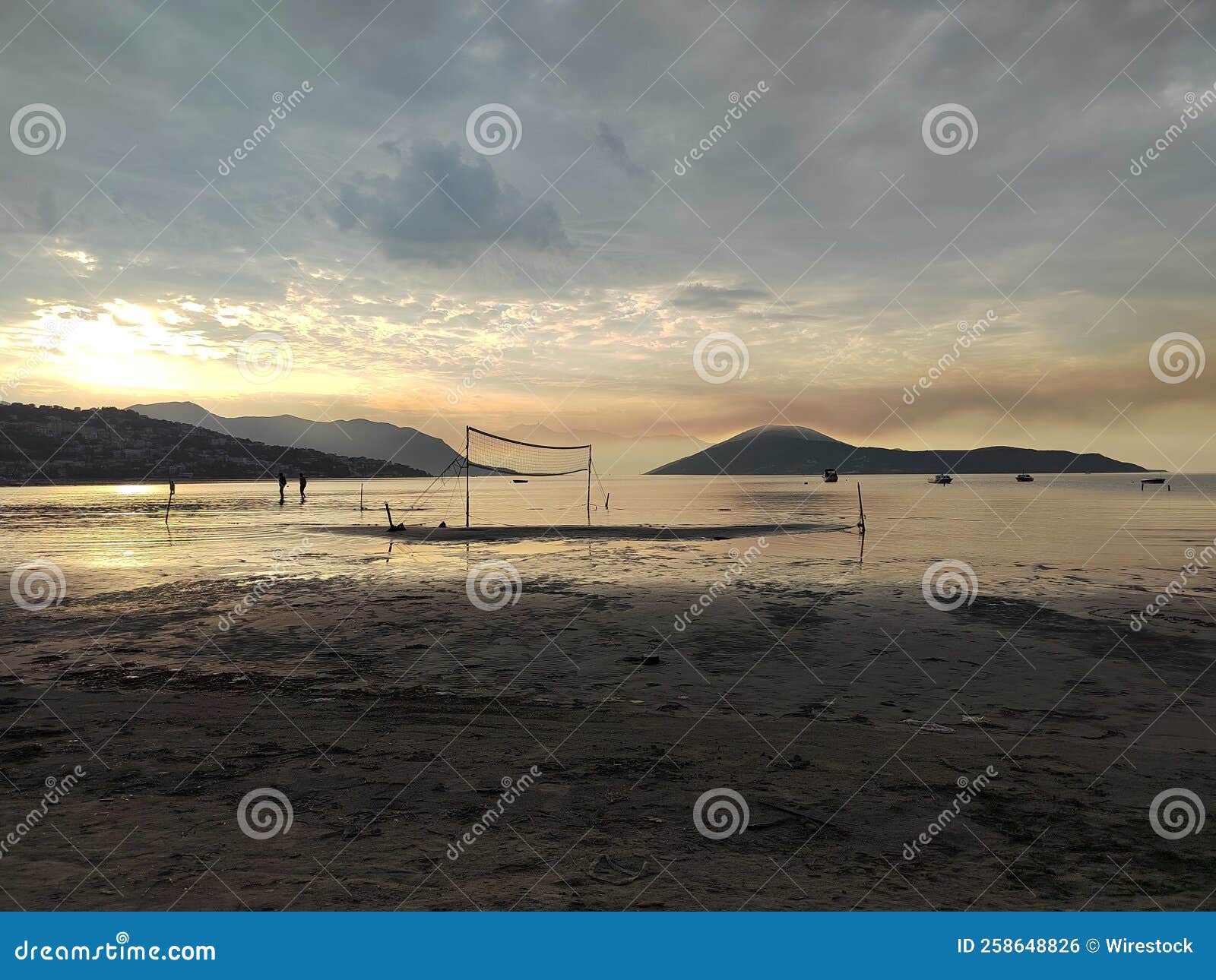 Muddy Beach with Footsteps at Sunset Cloudy Sky Stock Photo - Image of ...