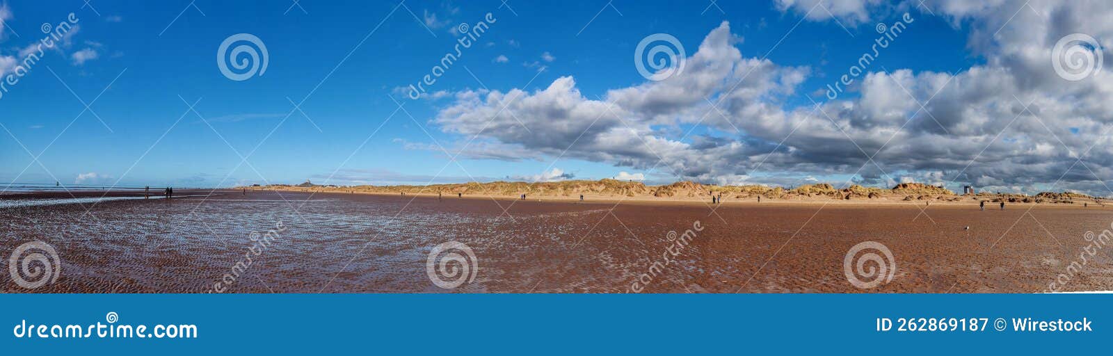Mudflat Beach with a Mountain Range Against the Scenic, Floating Clouds ...