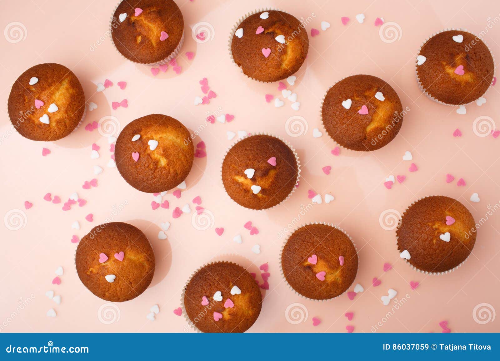 Muffins in Paper Forms and a Lot of Small Sugar Hearts on a Mirrored ...