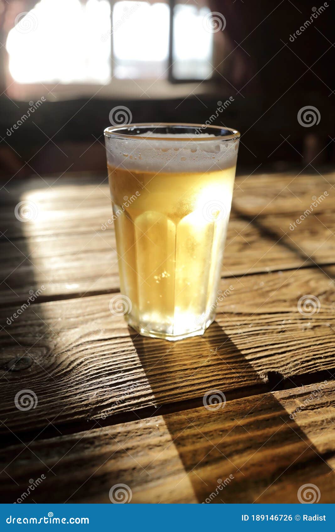 Mug of beer lit by light stock photo. Image of meal - 189146726