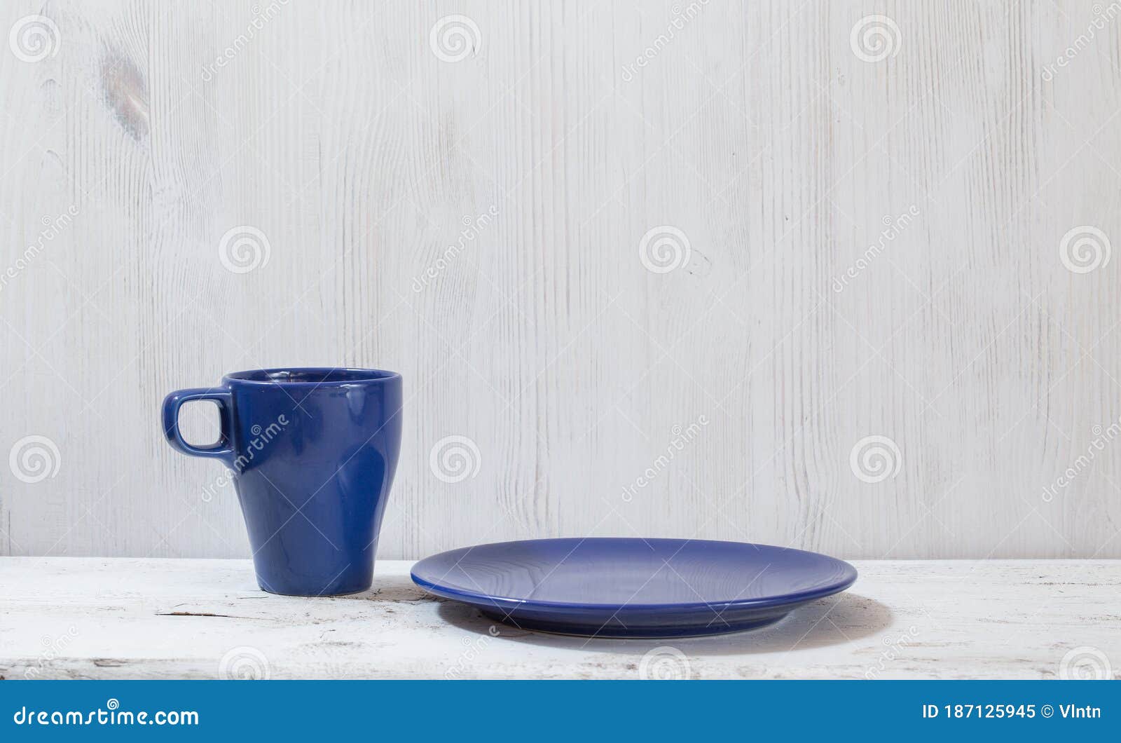 Mug and plates on table stock image. Image of wooden - 187125945