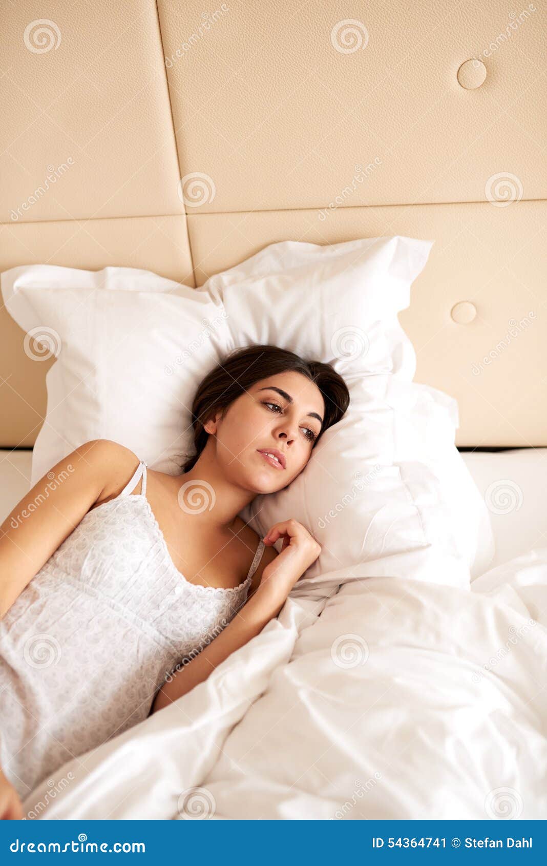 Mujer Que Miente En Cama Con La Cabeza En La Almohada Imagen De Archivo