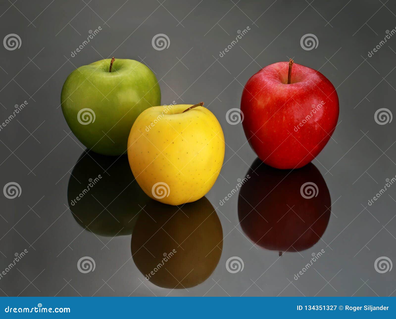 Multi Colored Apples on Reflective Black Background Stock Image - Image ...
