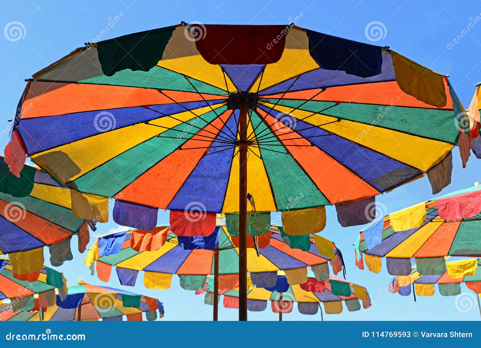 Multi-colored Beach Umbrella on Blue Sky Background Stock Image - Image ...
