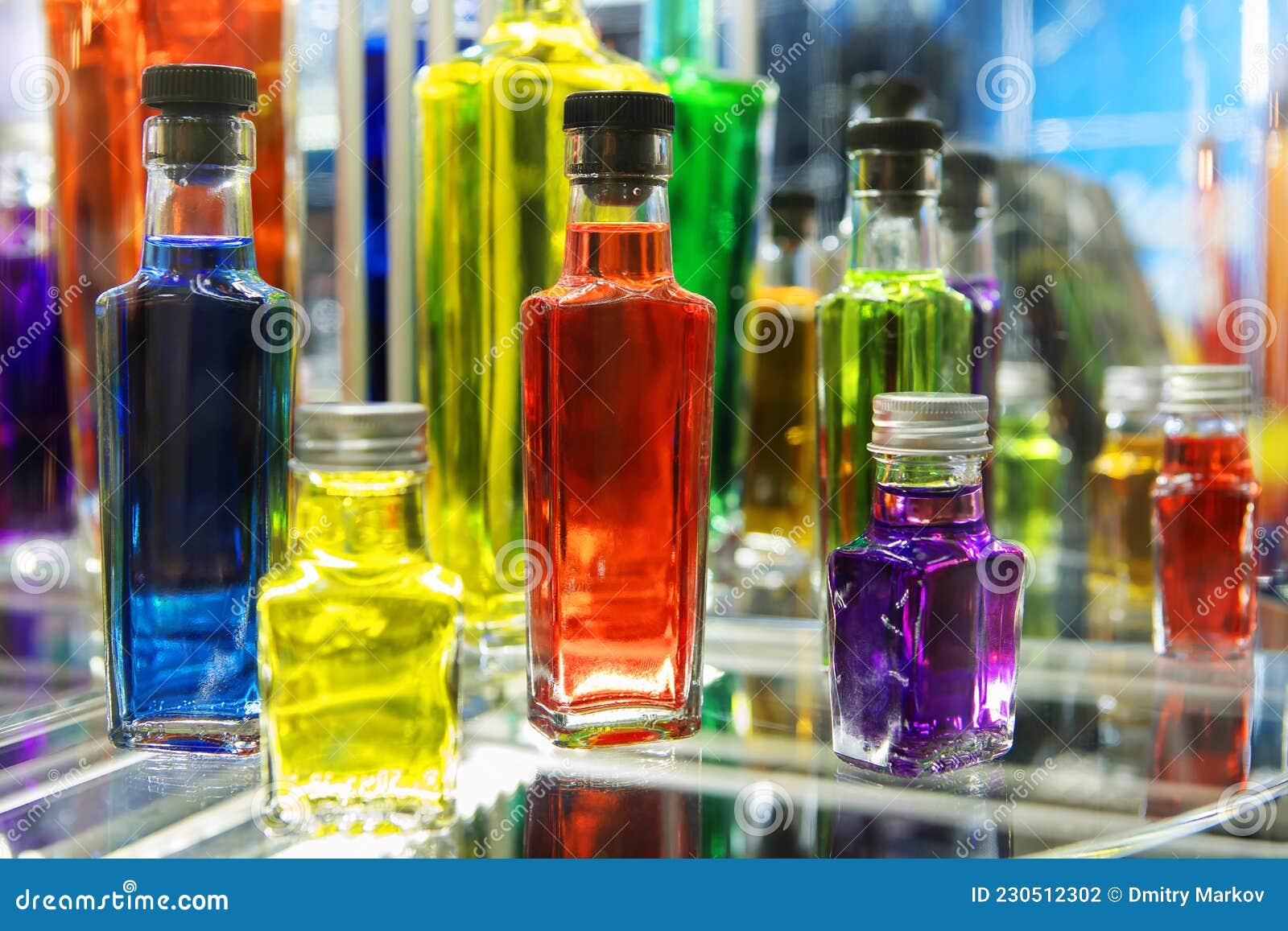 Multi-colored Bottles with Alcohol on a Glass Shelf. Collection of ...