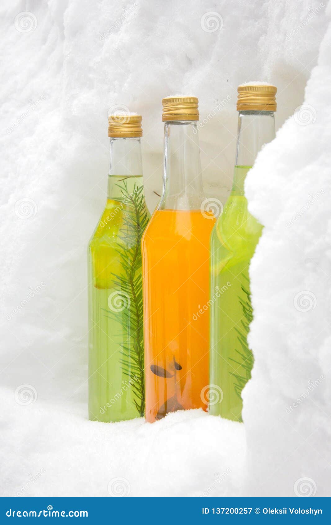 Bottles with Alcohol in the Snow.Multi-colored Bottles Stock Image ...
