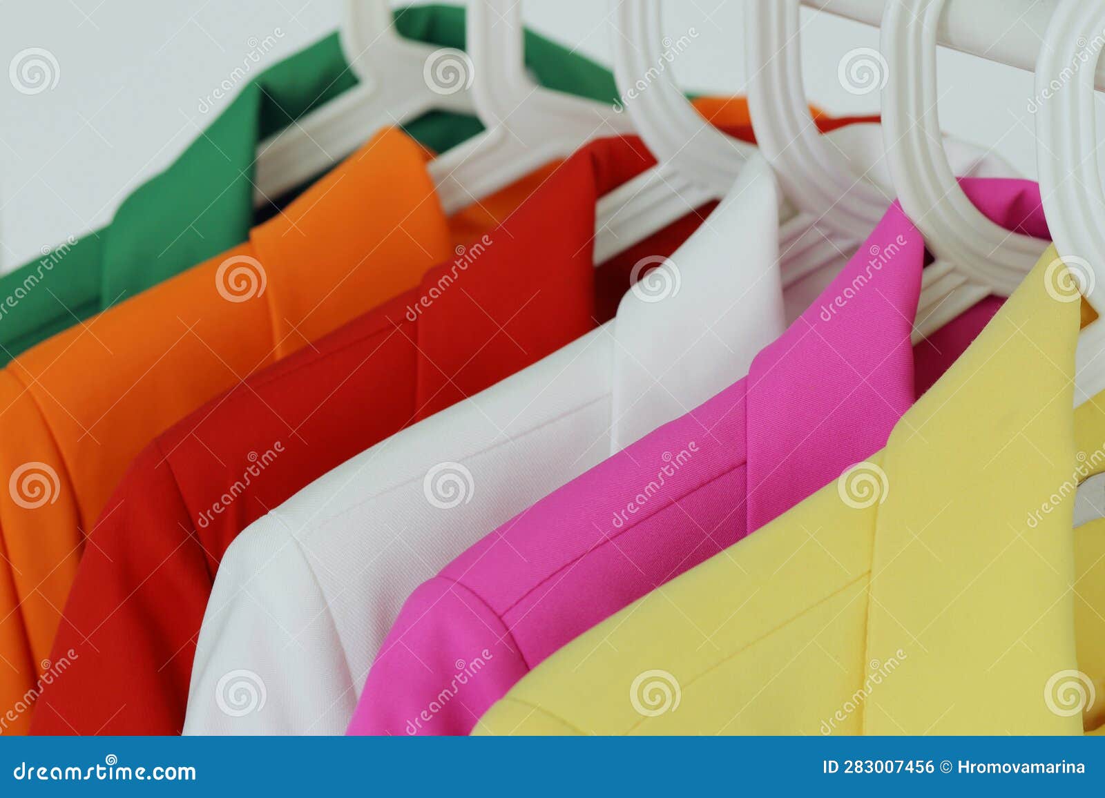 Multi-colored Bright Jackets on a Hanger on a White Background Stock ...