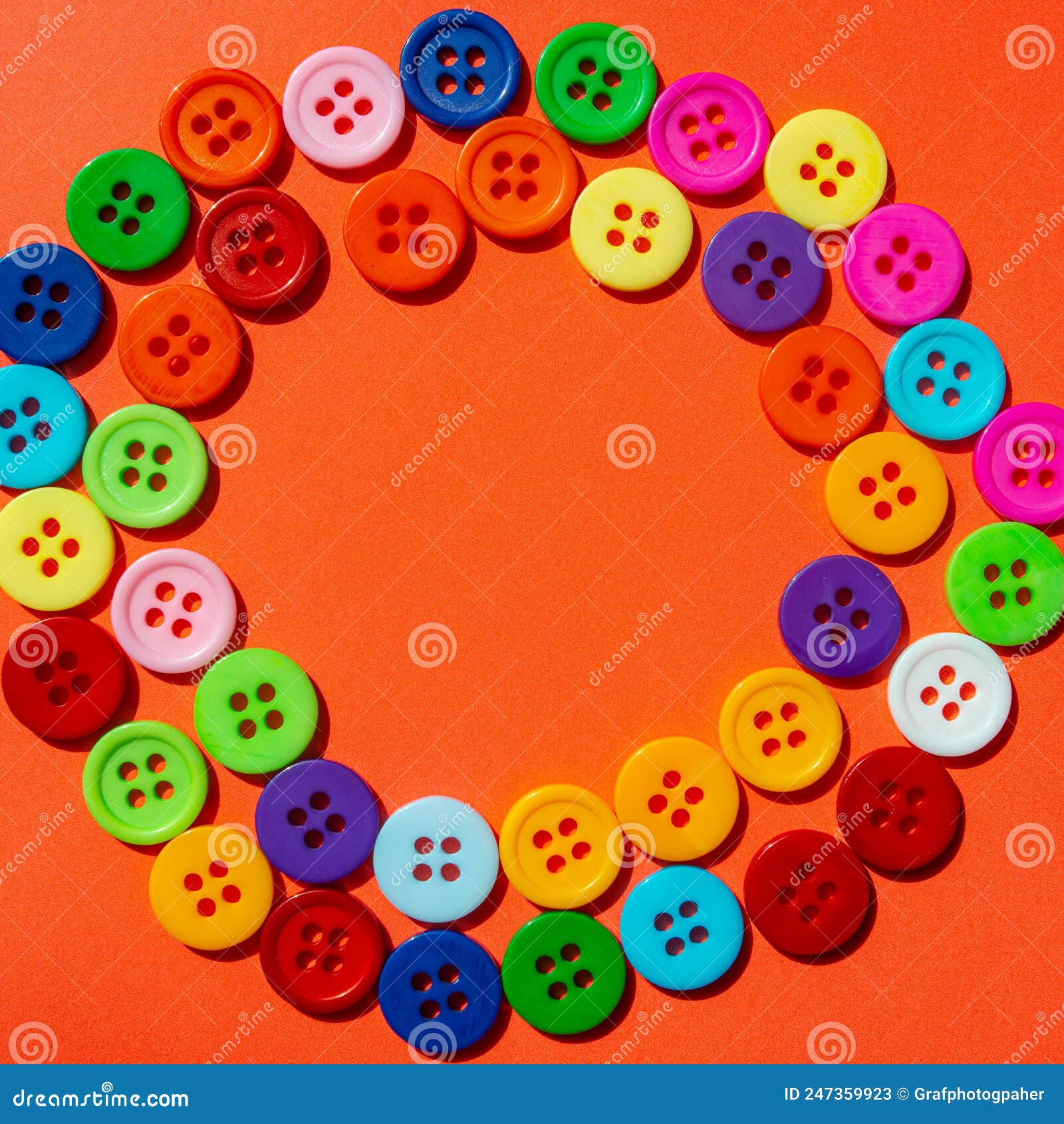 Multi-colored Buttons Lie in the Form of a Circle on an Orange ...