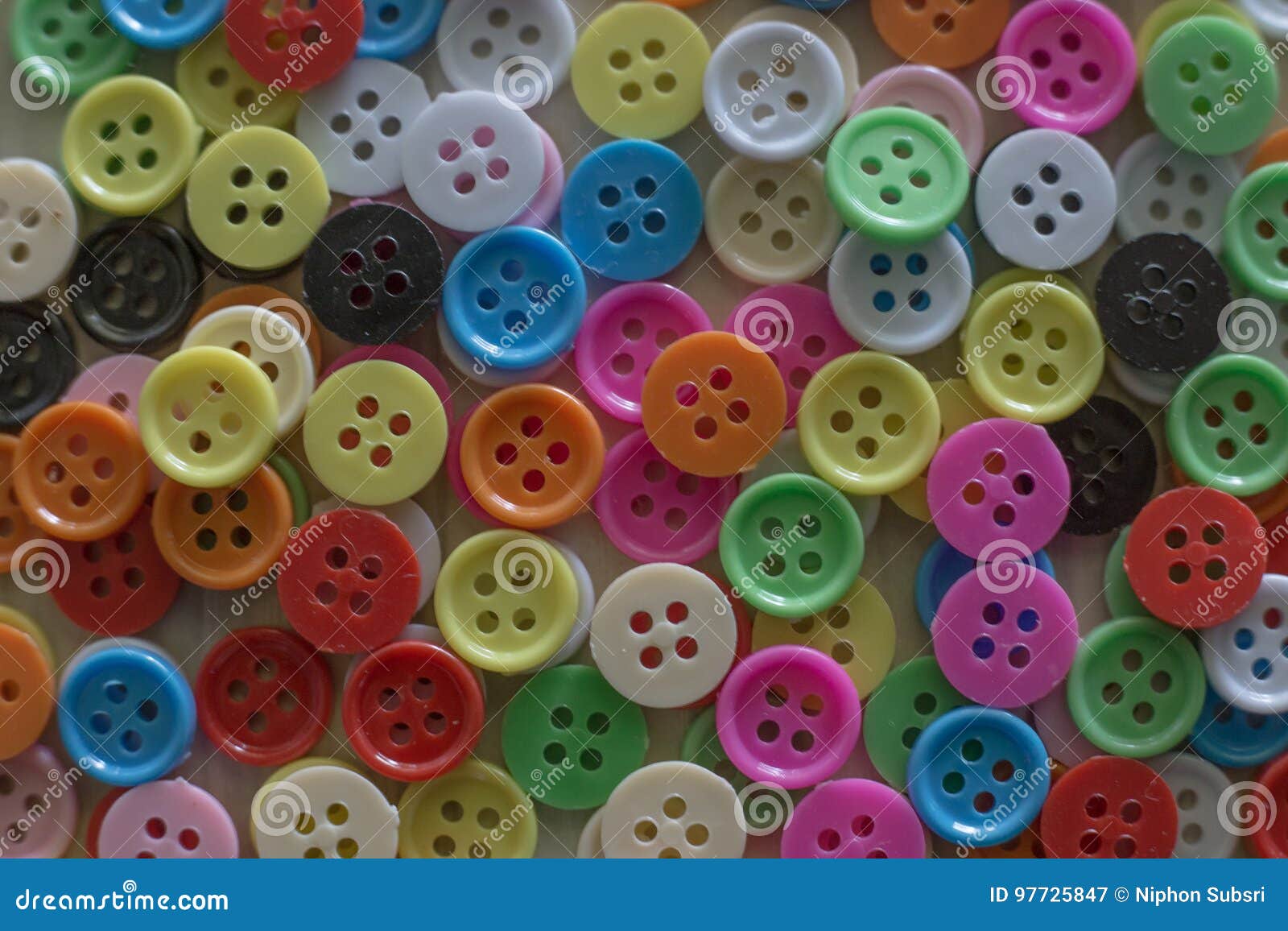 A Multi Colored Buttons on Light Wood Table Stock Image - Image of ...