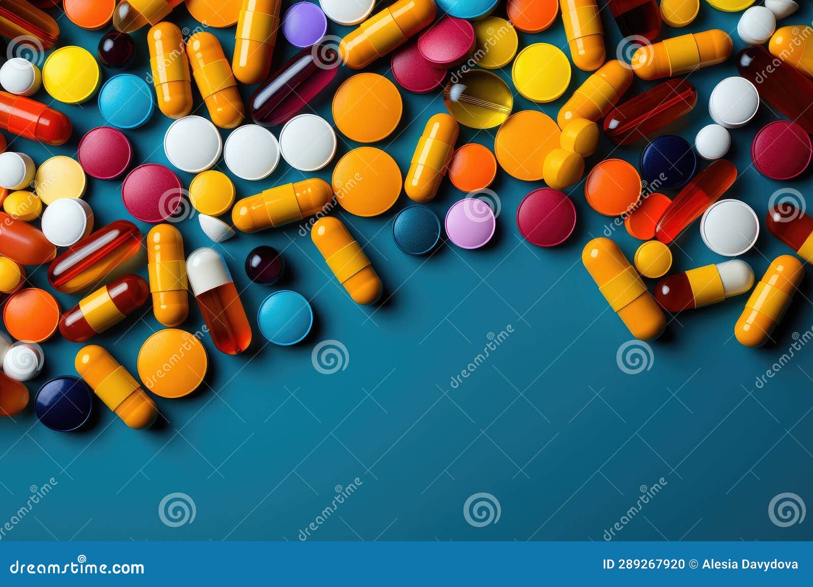 Multi-colored Capsules and Tablets Lie on the Side of a Blue Background ...
