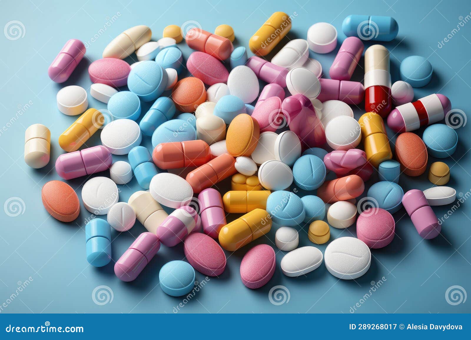 Multi-colored Capsules and Tablets Lie on the Side of a Blue Background ...