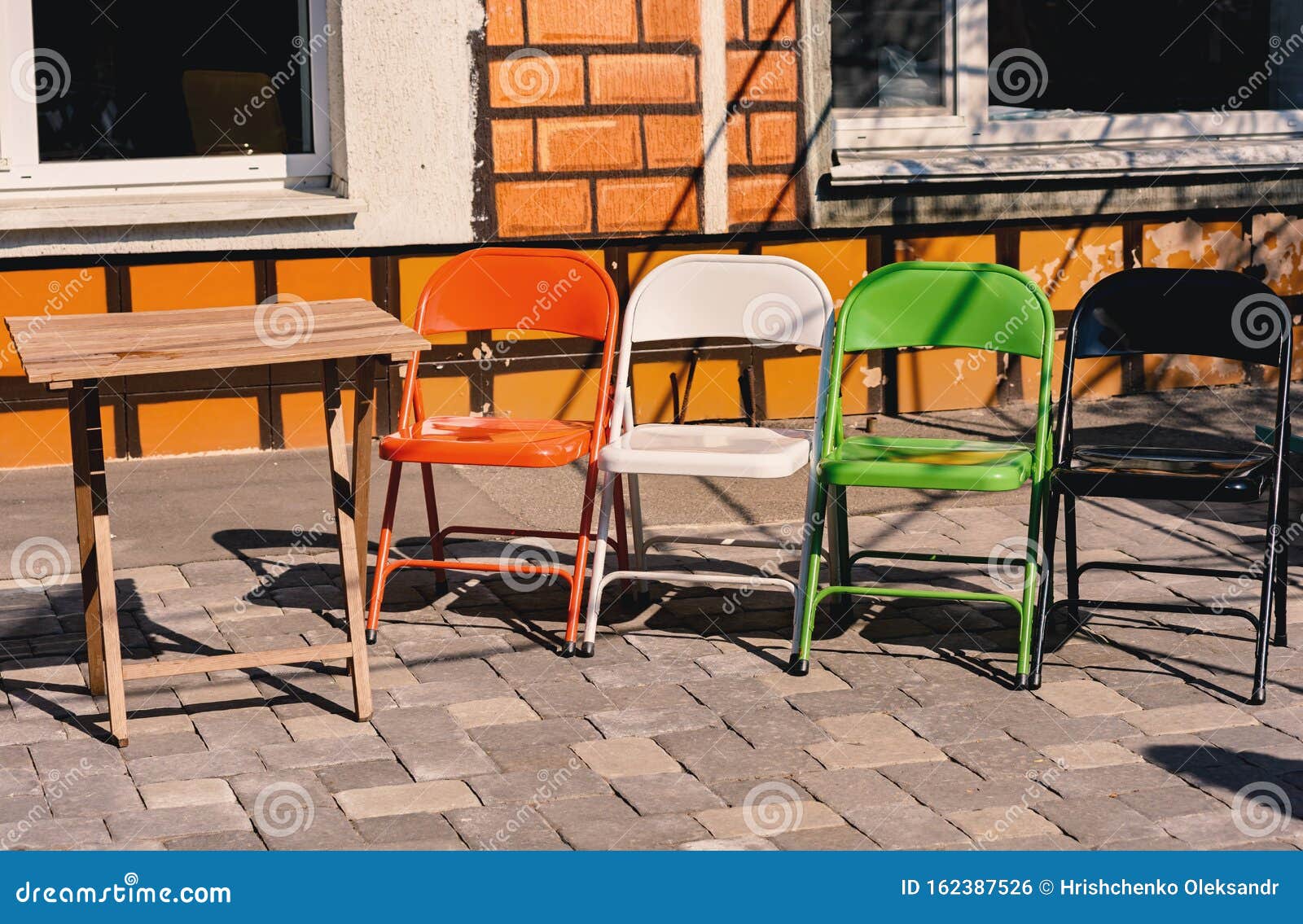 Multi-colored Chairs and Table in the Street Stock Photo - Image of ...