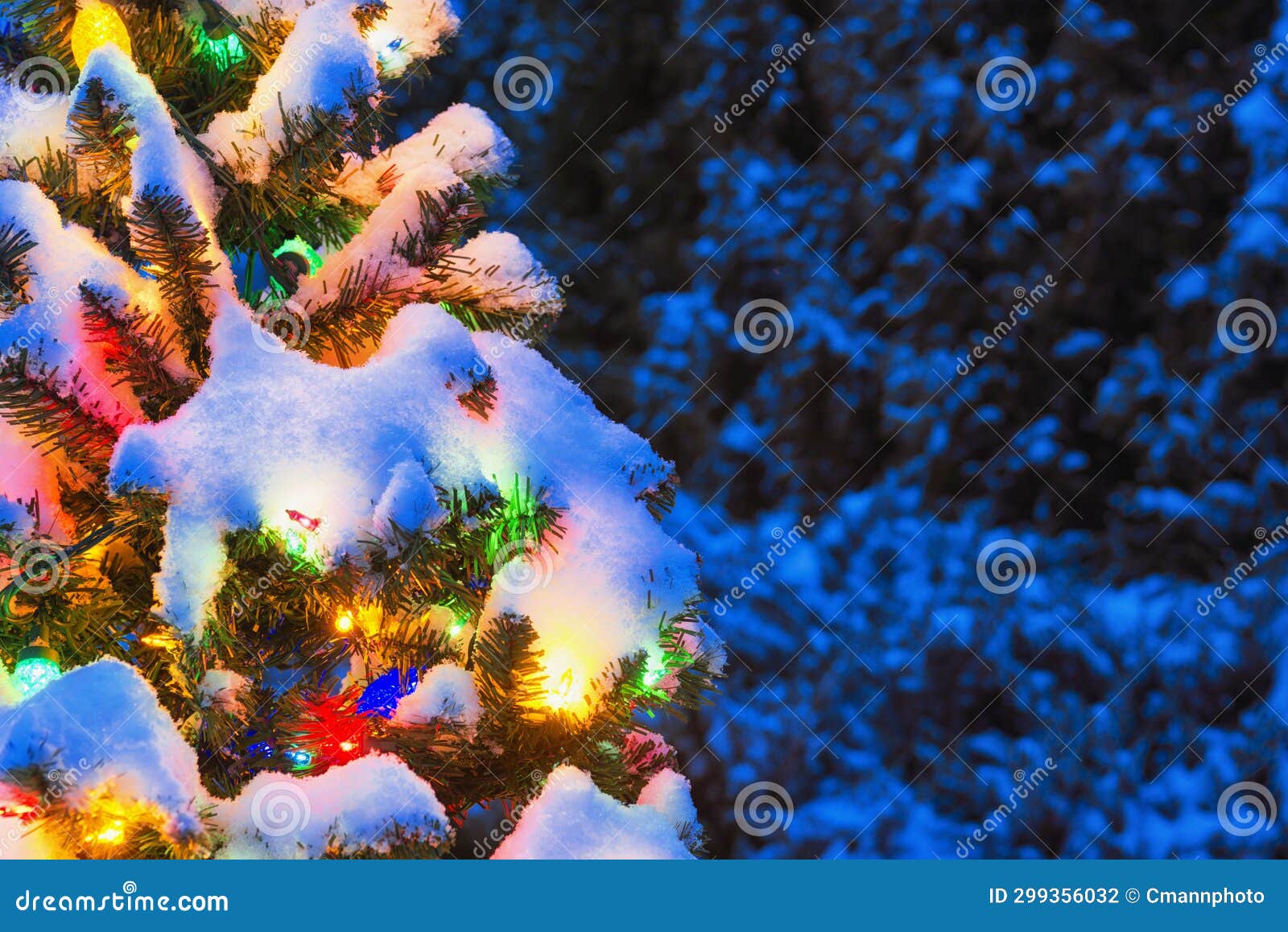 Multi-Colored Christmas Tree at Night while Snowing Stock Photo - Image ...