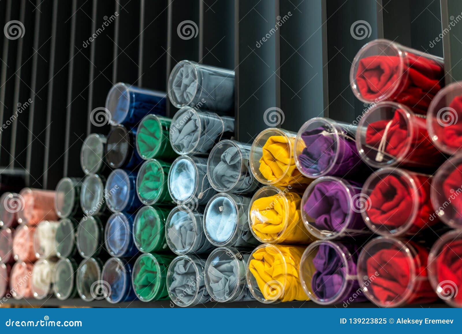 Multi-colored Clothes in Round Plastic Packages Stock Image - Image of ...