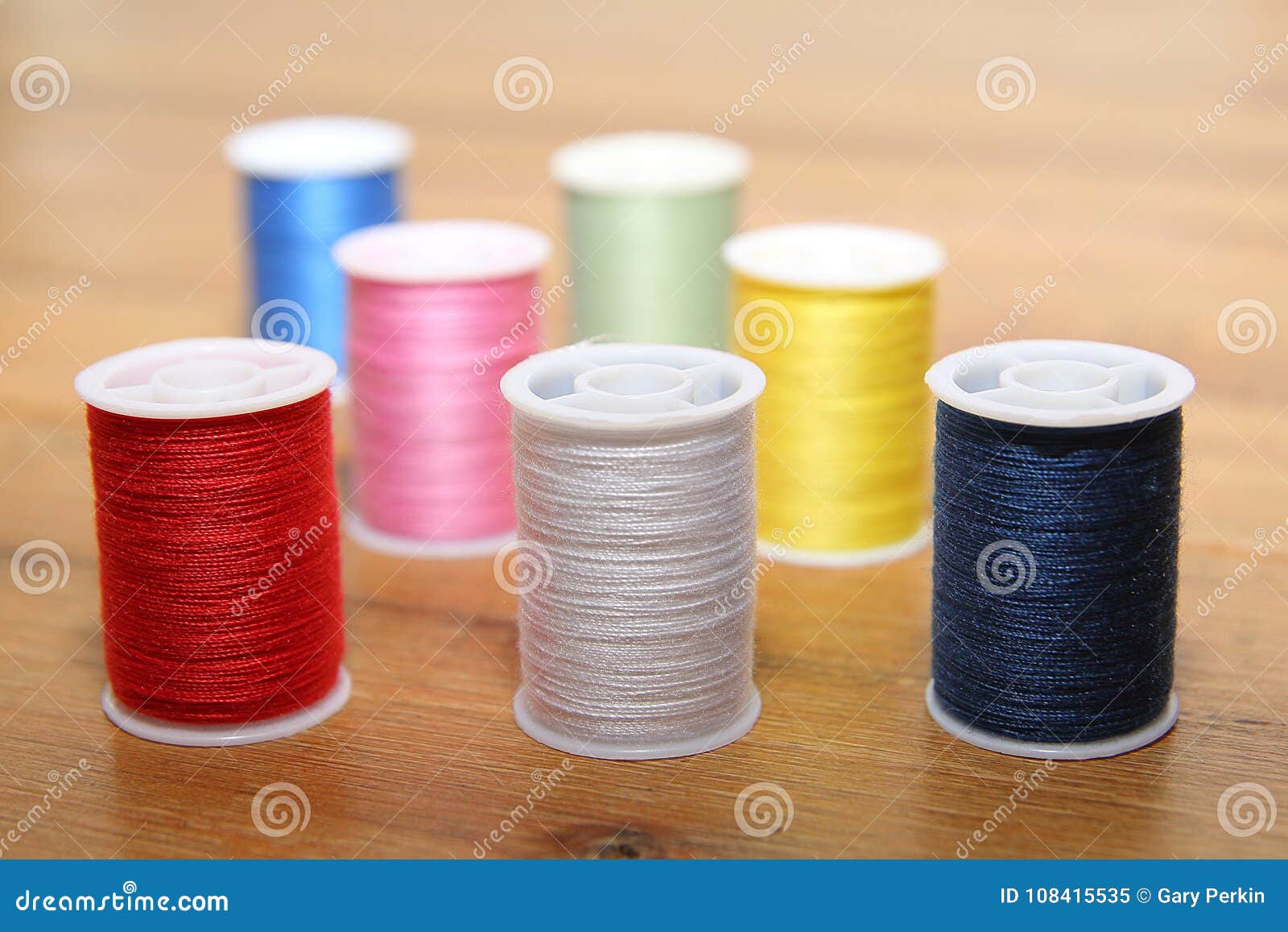 Multi-colored Cotton Reels or Bobbins on a Wooden Sewing Table Stock ...