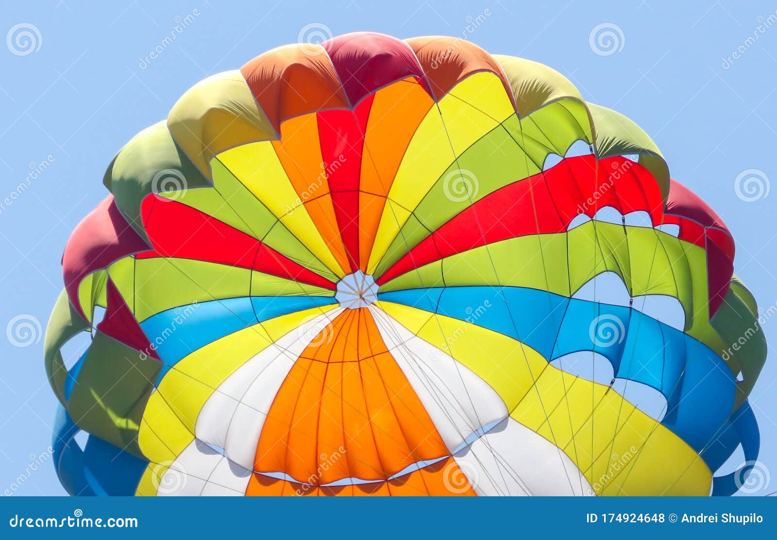 A Multi-colored Dome of a Parachute in the Sky As a Background Stock ...