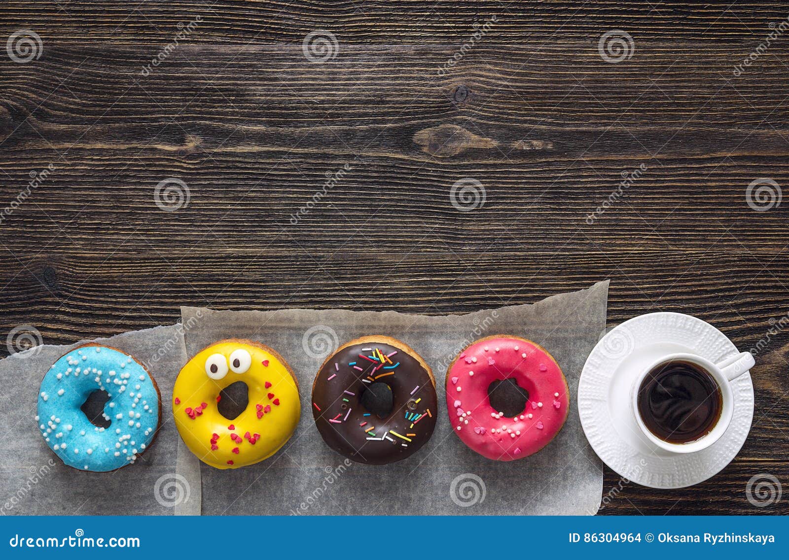 Multi-colored Donuts with a Cup of Coffee on a Wooden Table. Cop Stock ...
