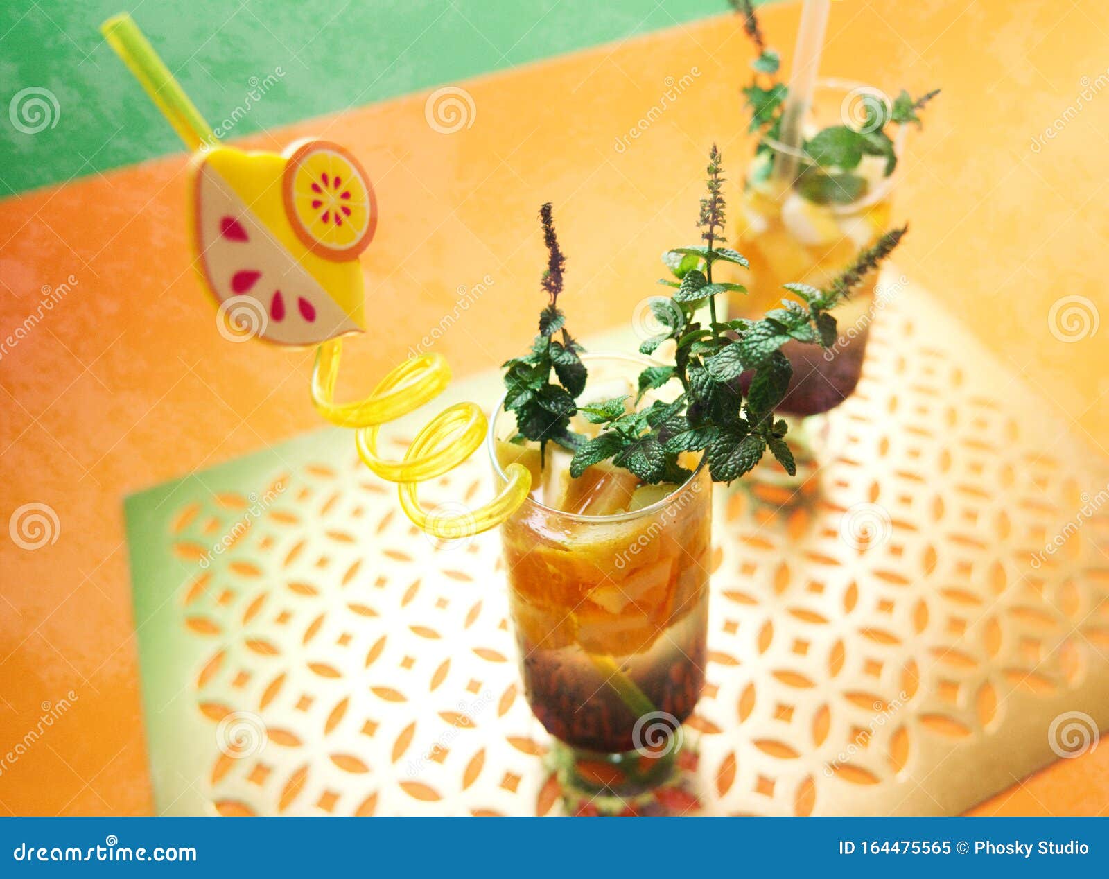 Multi-colored Drinks with Pieces of Fruit, Mint and an Unusual Straw ...
