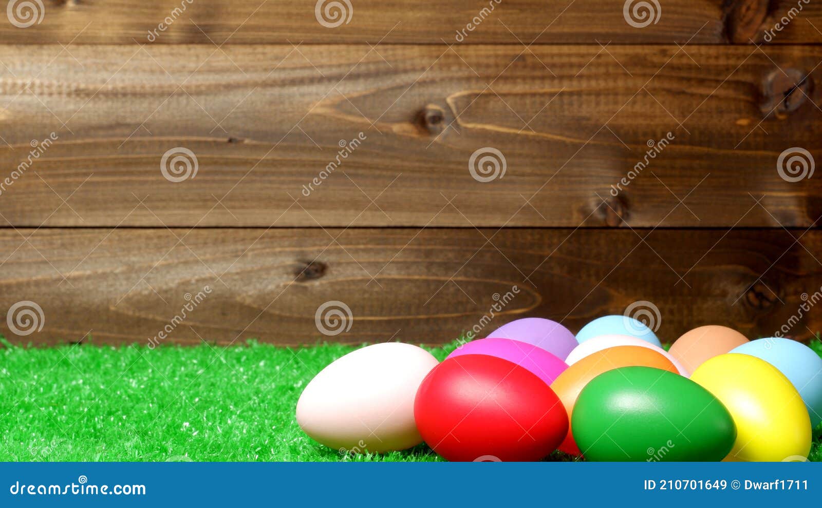 Multi Colored Easter Eggs on Green Grass Lawn and Wooden Panks ...