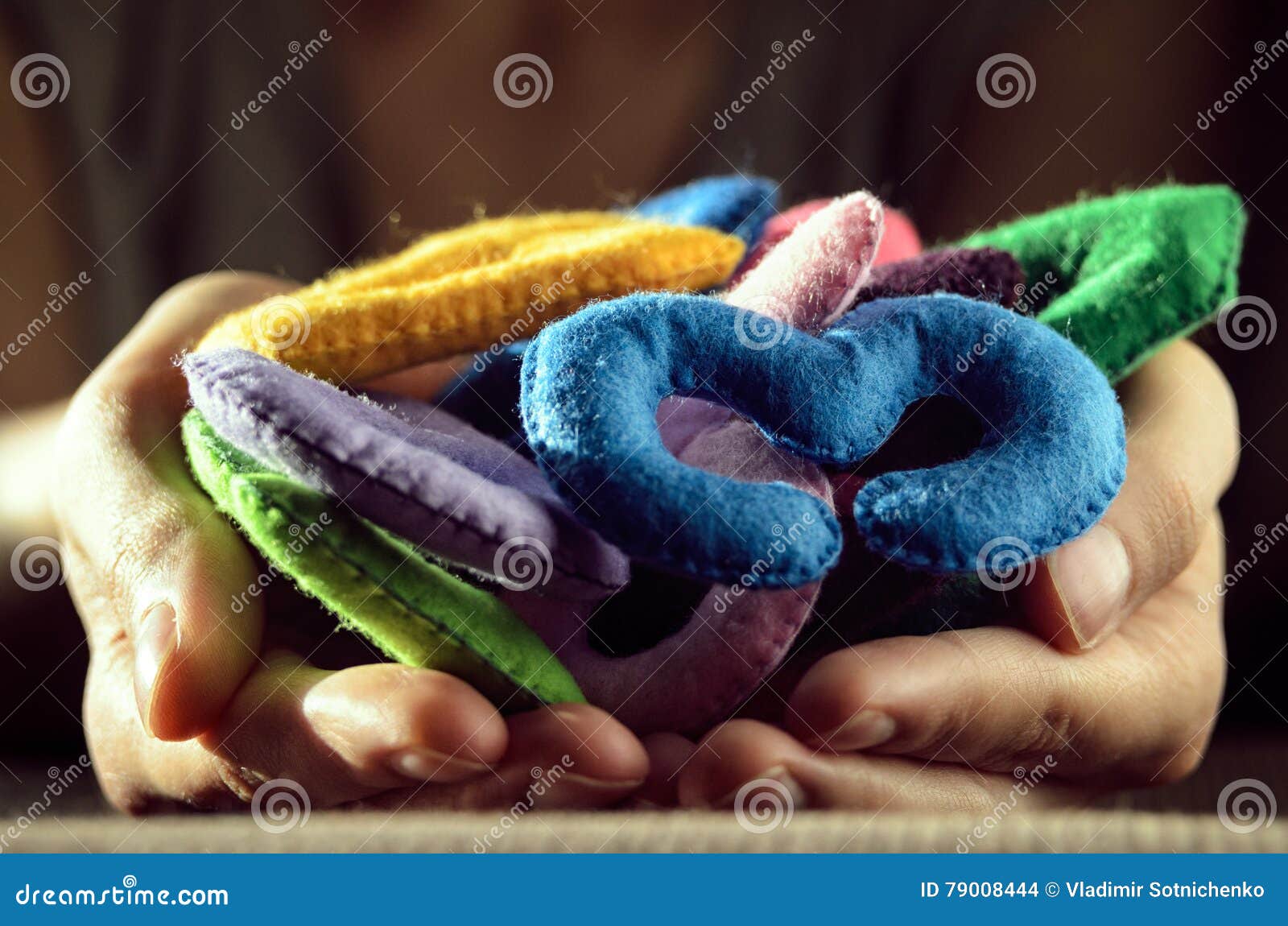Multi-colored Figures of Felt in the Palms Stock Photo - Image of ...