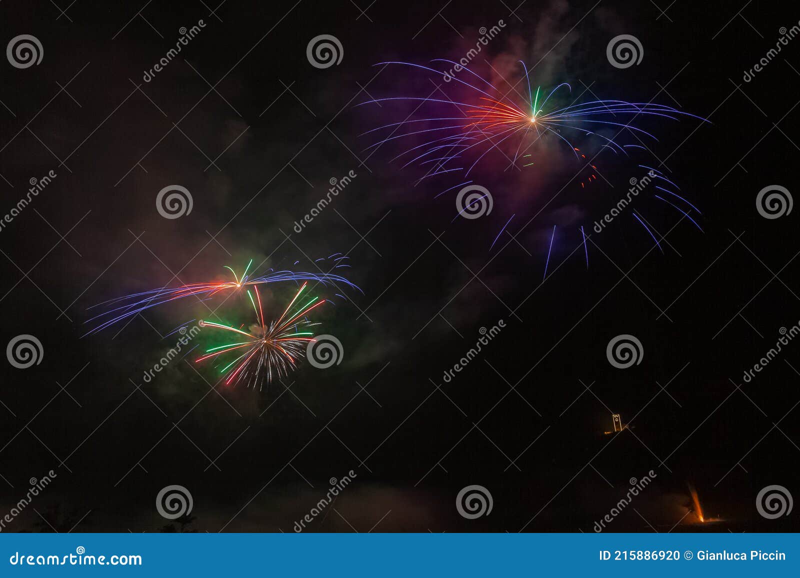 Multi Colored Fireworks Making Wake Effect Over Trees Silhouette Stock ...