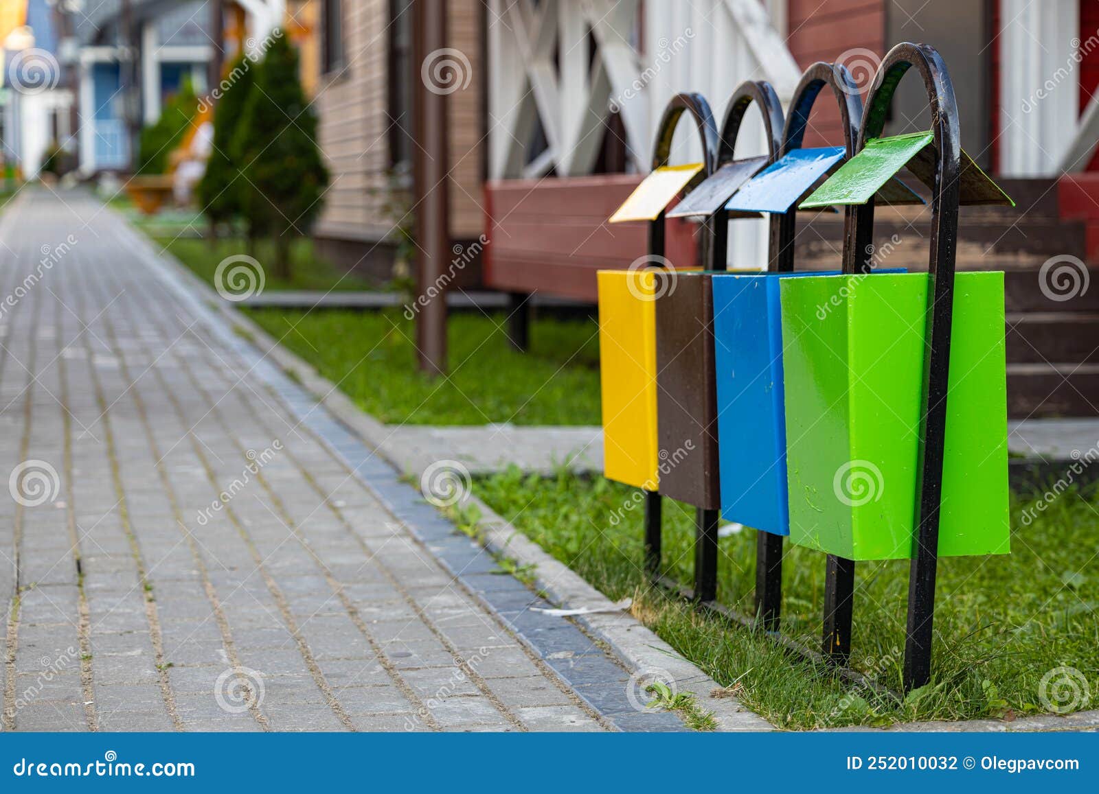 Multi-colored Garbage Containers Line the Path on the Street Stock ...