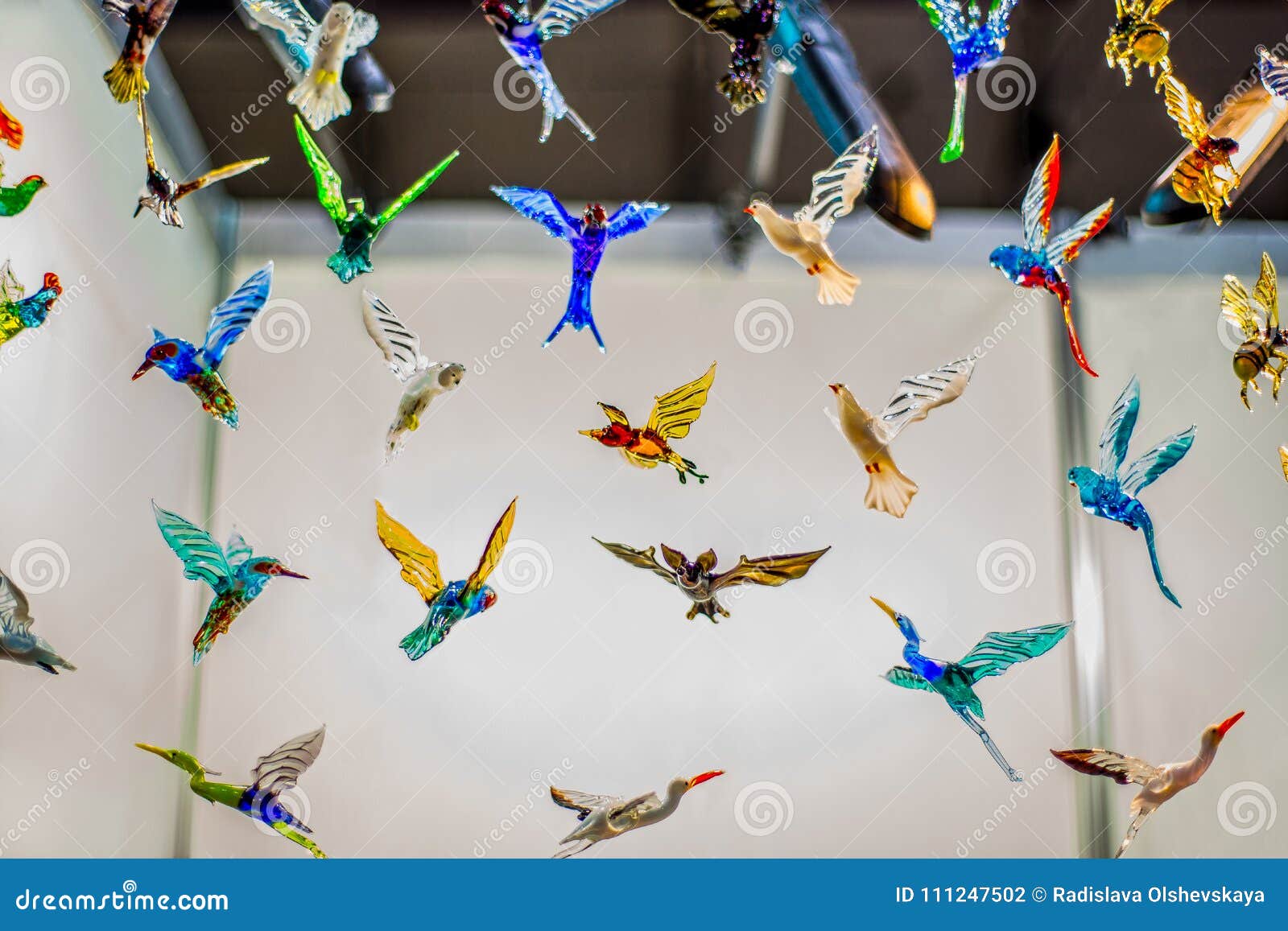 Multi-colored Glass Birds Hang on Strings. Stock Photo - Image of ...