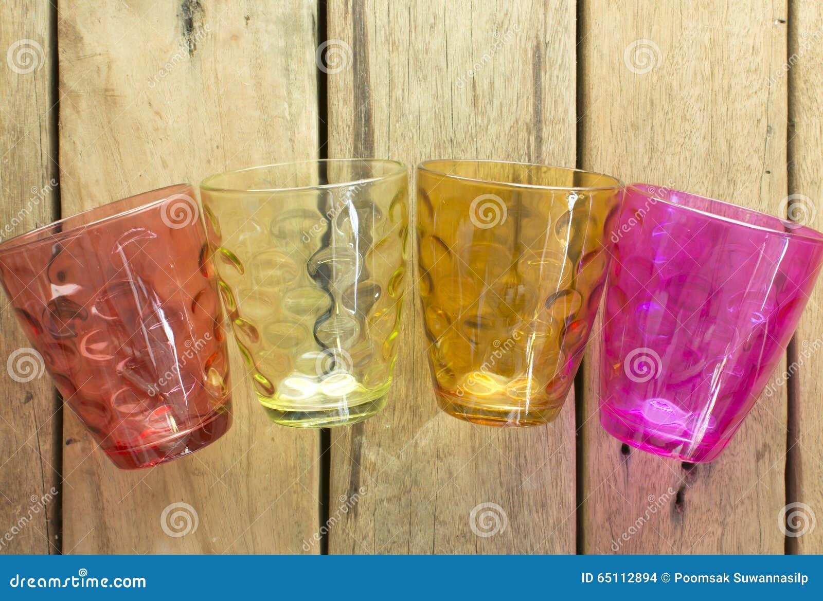 Multi-colored Glasses of Water, Which is Placed on a Wooden Table ...