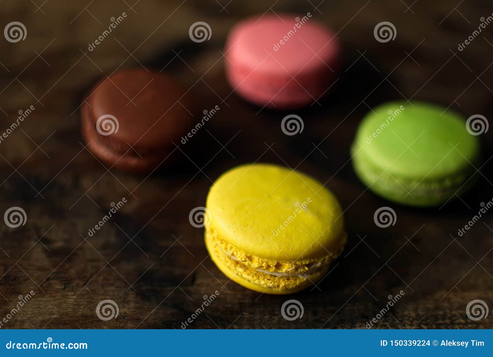 Multi-colored Macaroons on a Wooden Tray. Pink, Yellow and Green ...
