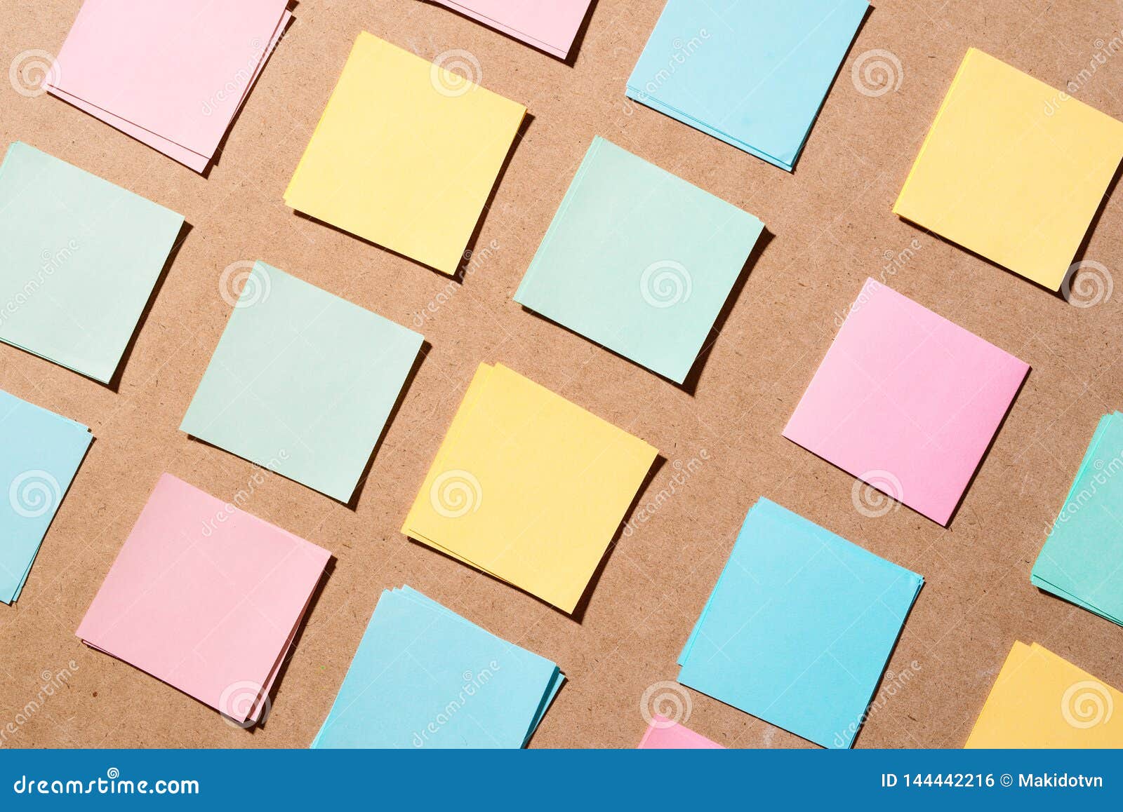 Multi Colored Notepads Laying on a Wooden Plank Board Surface with Copy ...
