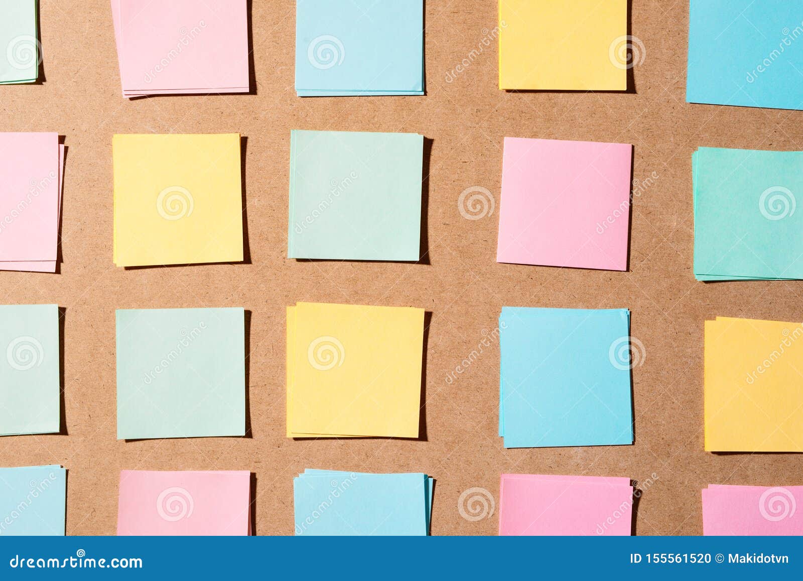 Multi Colored Notepads Laying on a Wooden Plank Board Surface with Copy ...