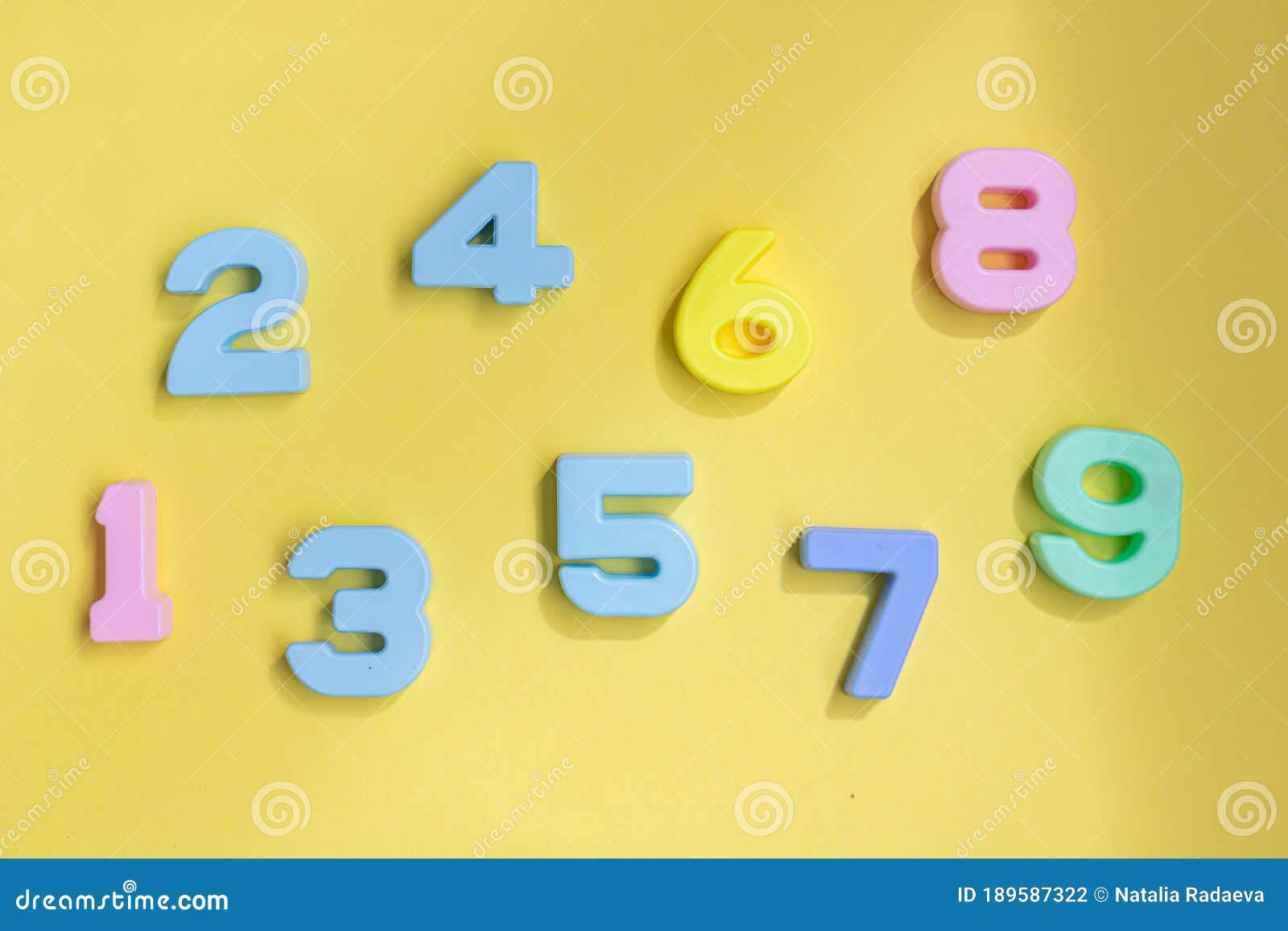 Multi-colored Numbers on a Yellow Background Top View. Child ...