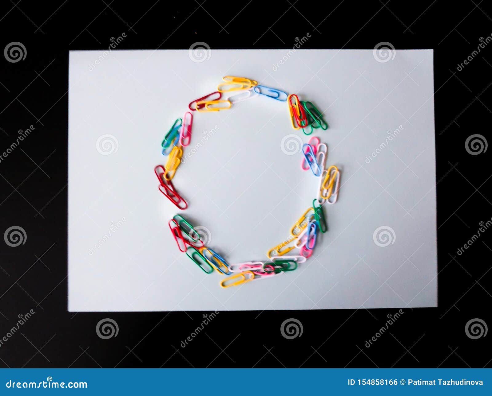 Multi-colored Paper Clips in the Form of a Circle on a White Sheet of ...