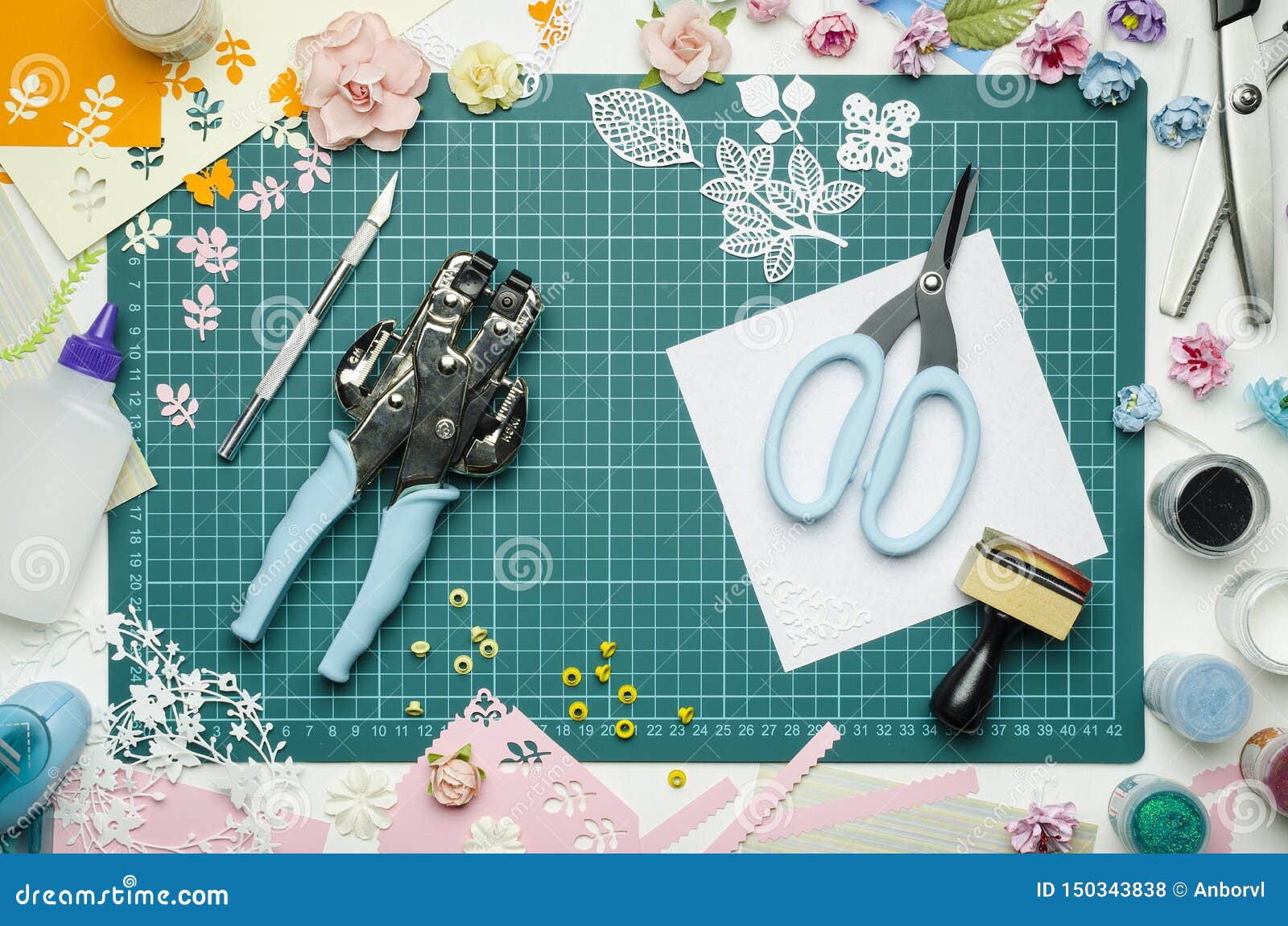 Multi-colored Paper Crafts on the Cutting Mat and Scrapbooking Tools ...