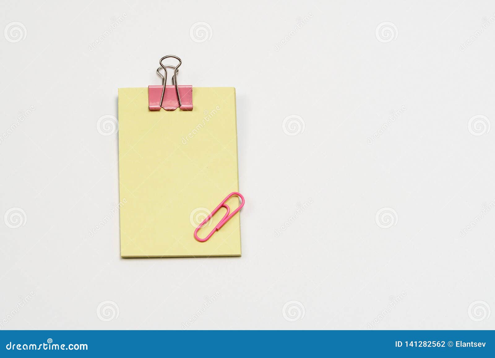 Multi-colored Paper Notes Fastened with a Paper Binder Clip on a White ...
